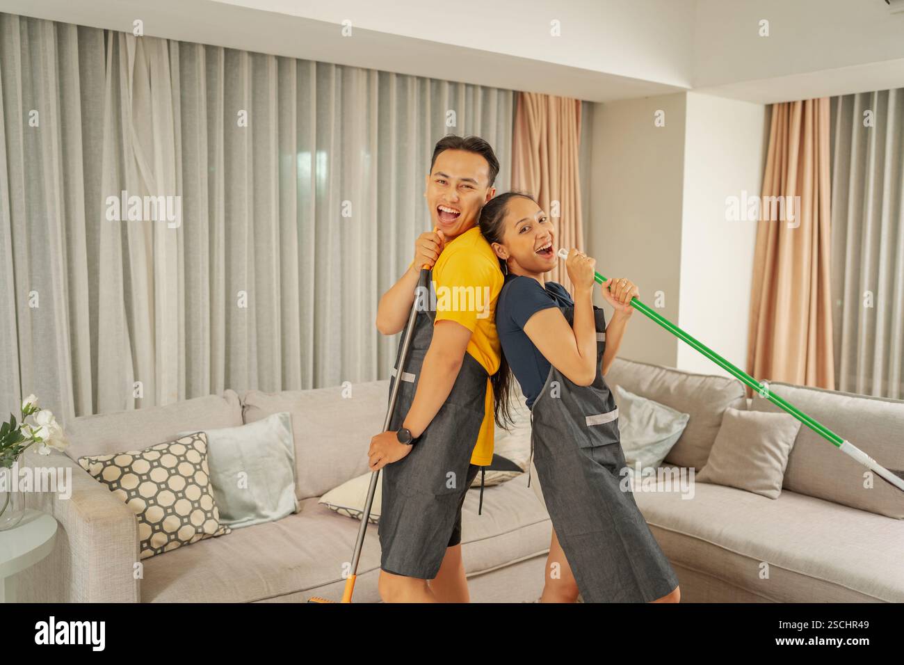 Fun Cleaning Duo Enjoying Joyful Moments Together While Tidying Up at ...