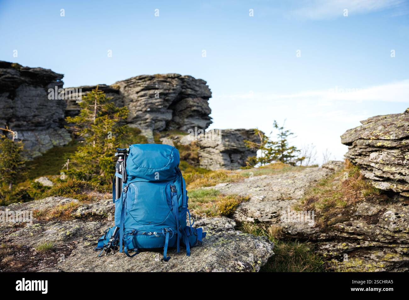 Hiking backpack with tripod on rock during trekking in mountains. Hike ...