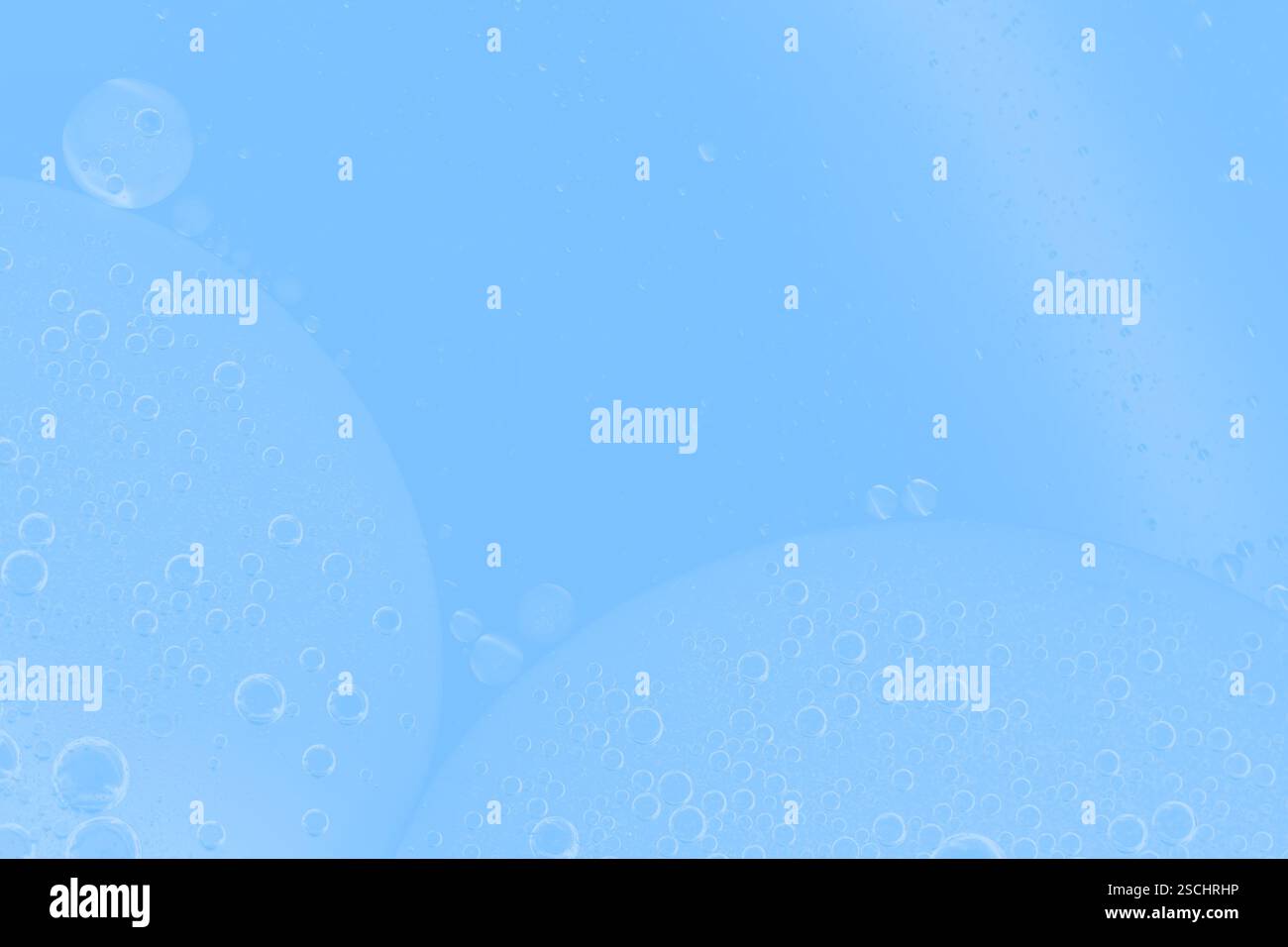 Transparent water bubbles rising in a soft blue liquid background ...