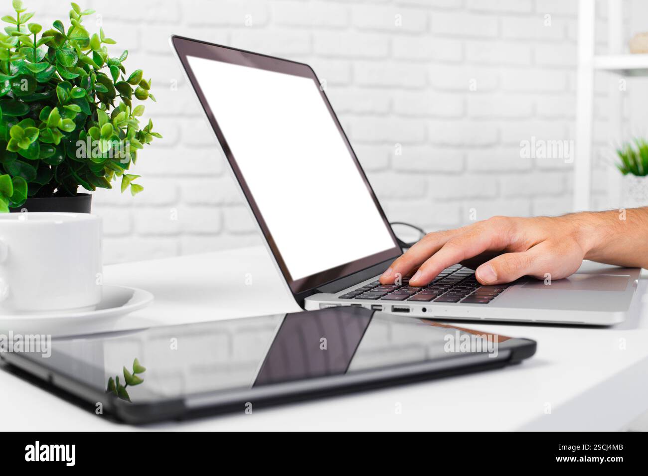 Technology workspace featuring a laptop, tablet, and coffee, ideal for ...