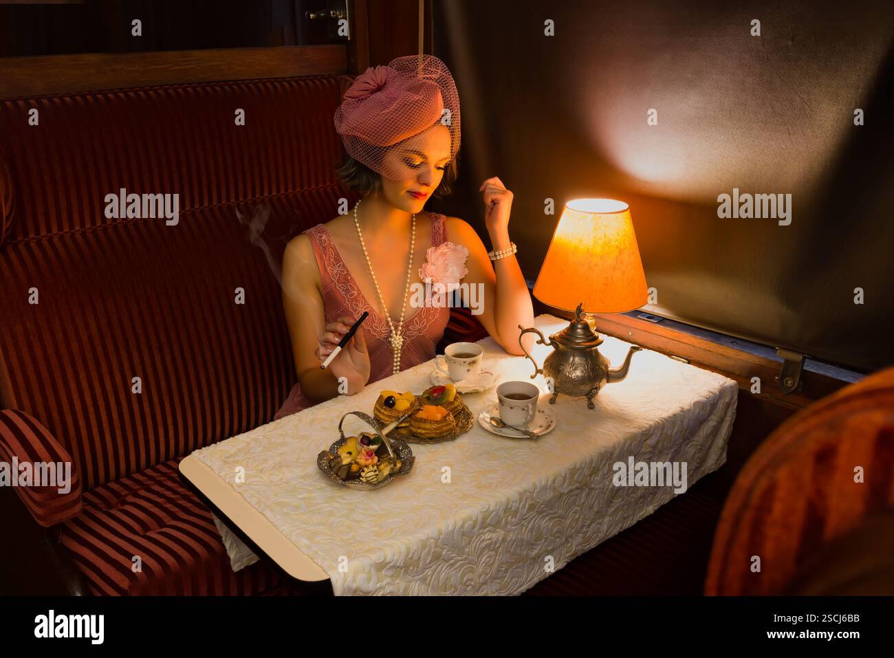 Reenactment scene of a 1920s flapper dress lady enjoying high tea in an ...