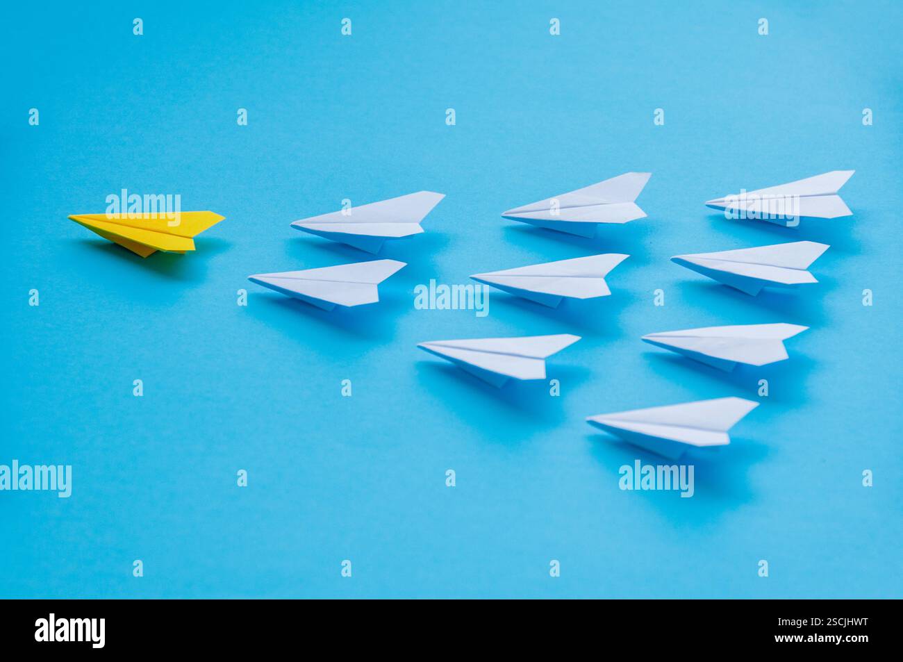 Leadership concept, yellow paper airplane origami leading other white ...