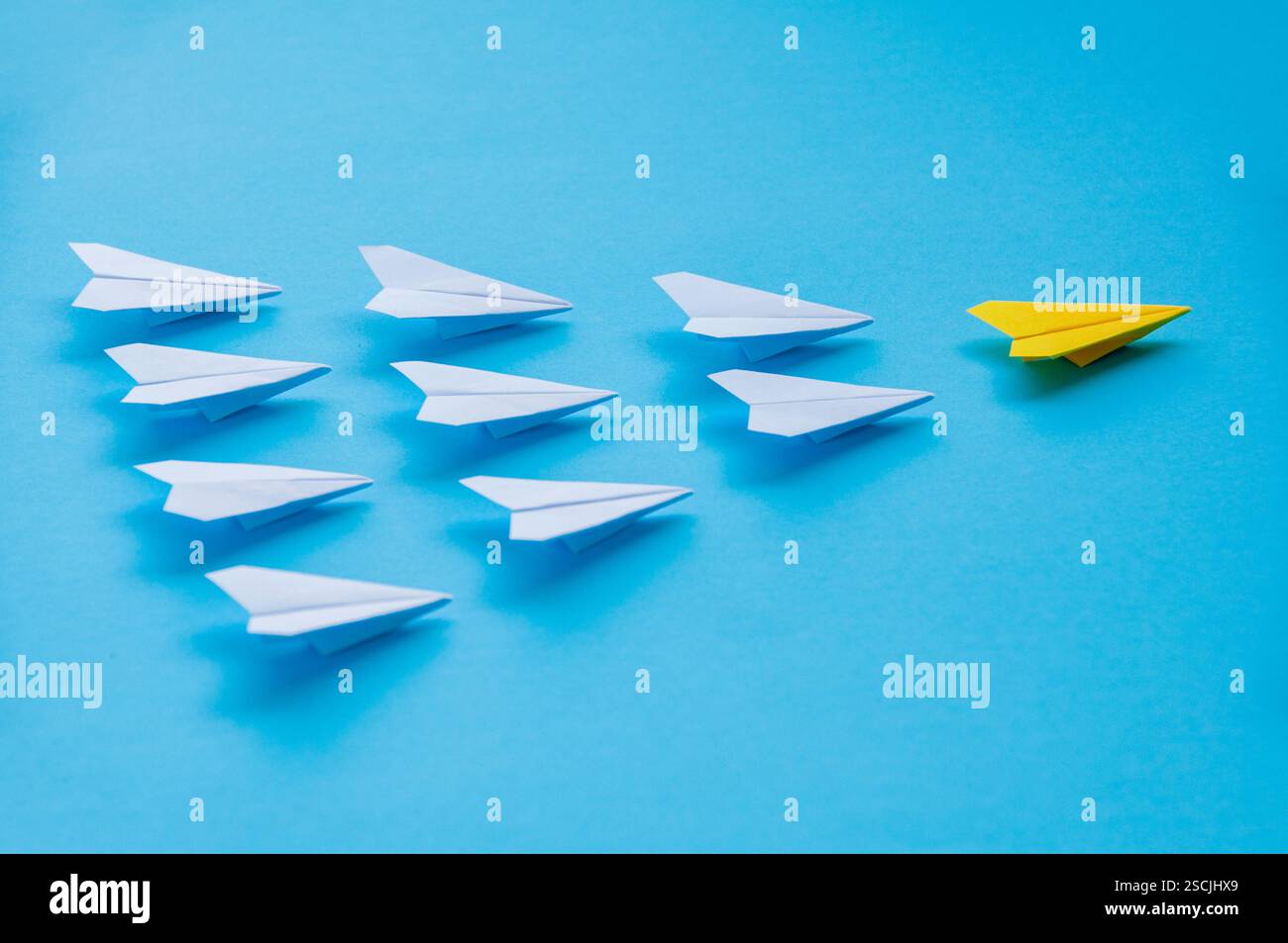 Leadership concept, yellow paper airplane origami leading other white ...