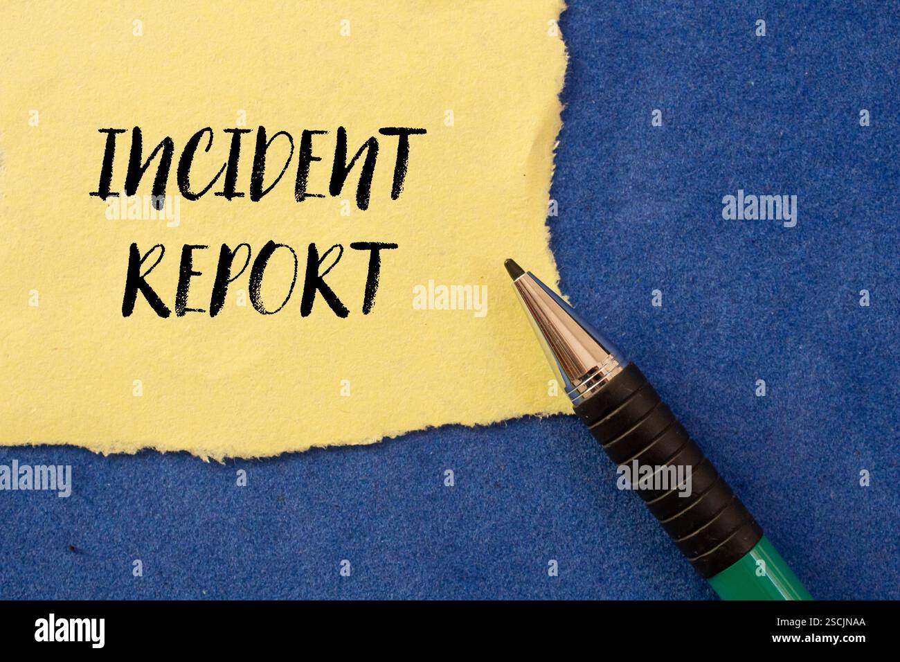 Incident report message written on ripped torn yellow paper on blue ...