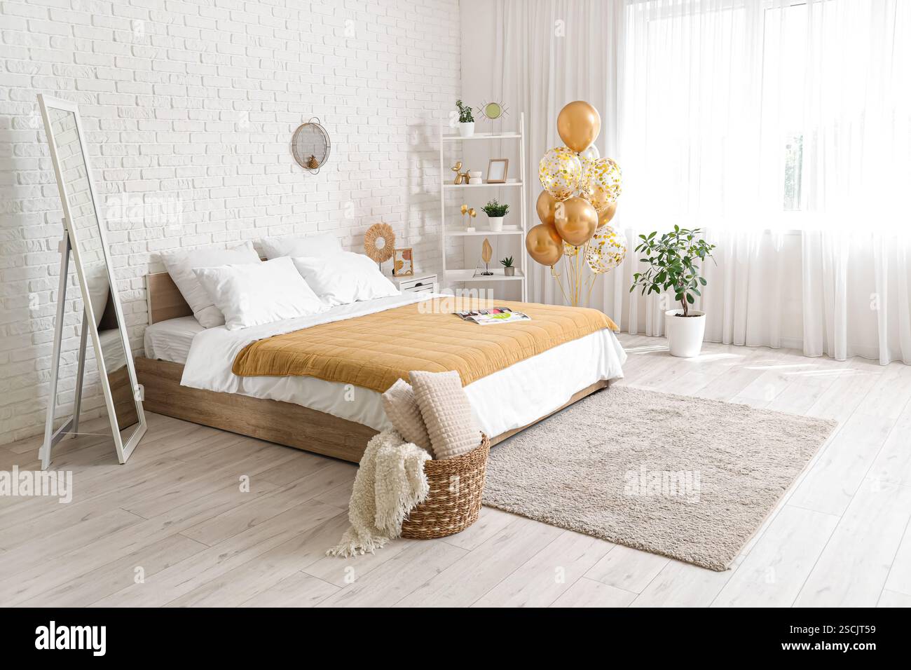 Cozy bedroom with big bed and air balloons near window Stock Photo - Alamy