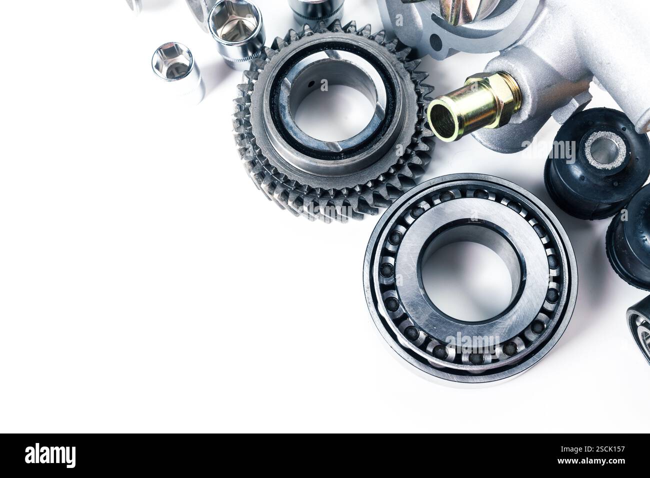 Various mechanical parts and components arranged neatly on a white ...