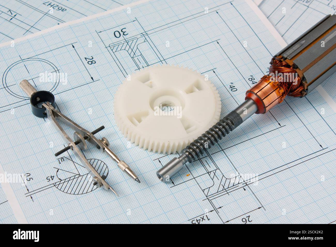 electrical components and stationery measuring tools against drawings ...