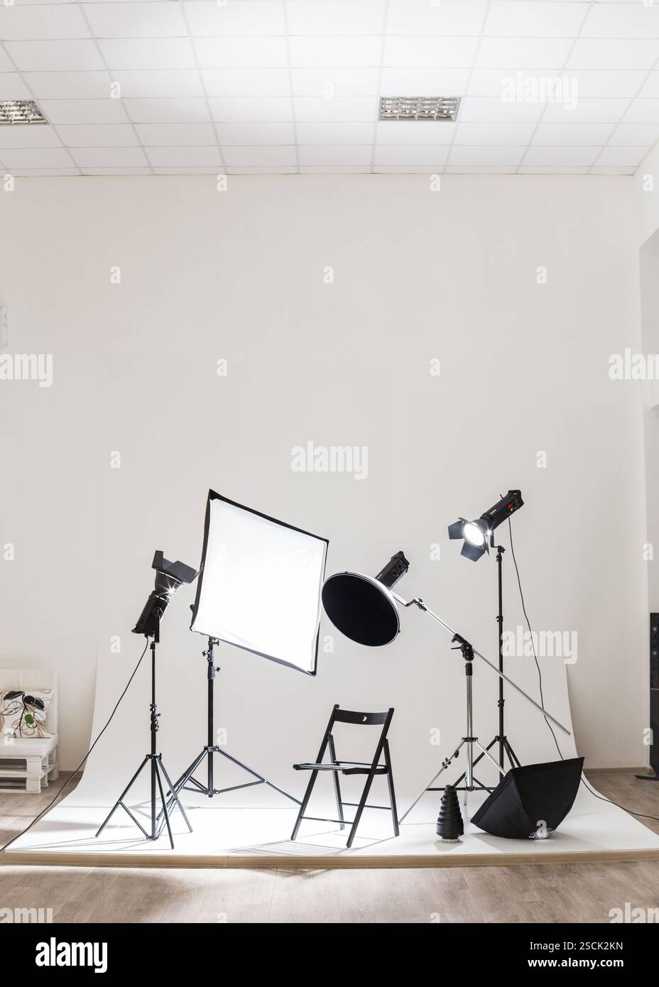 Studio setup with lighting equipment and chair ready for a creative ...