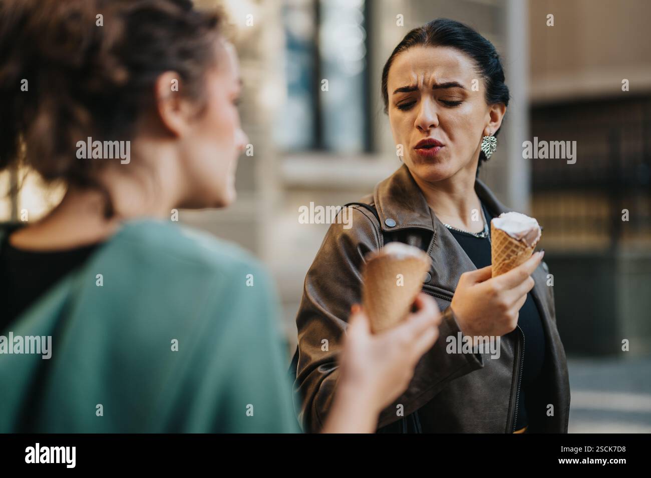 Two women enjoying ice cream with curious facial expressions Stock ...