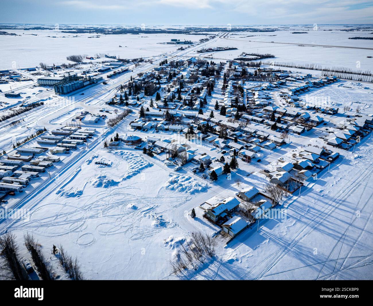 Snowy town with houses and a railroad. The houses are mostly empty and ...