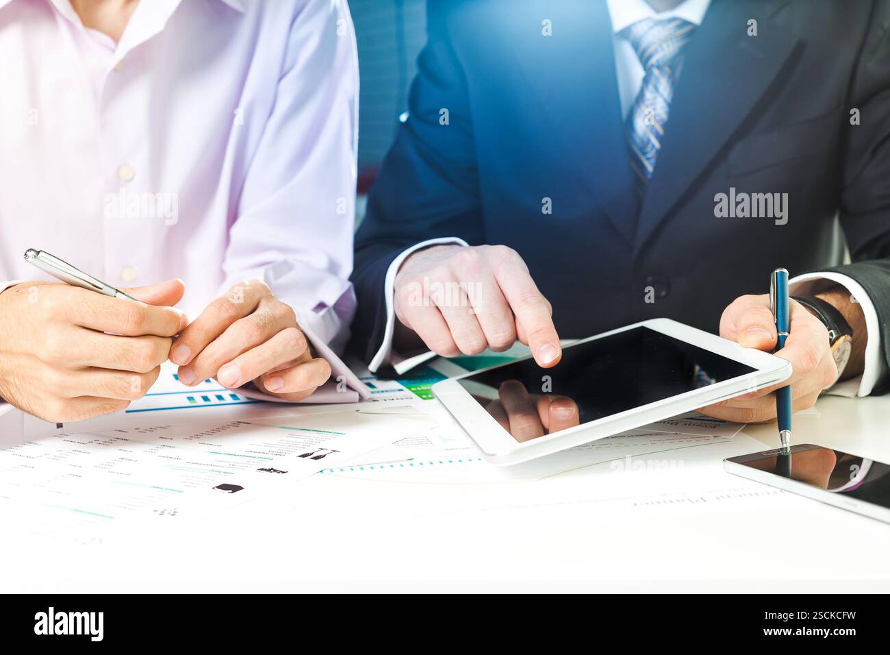 Business meeting with professionals taking notes in a modern office ...