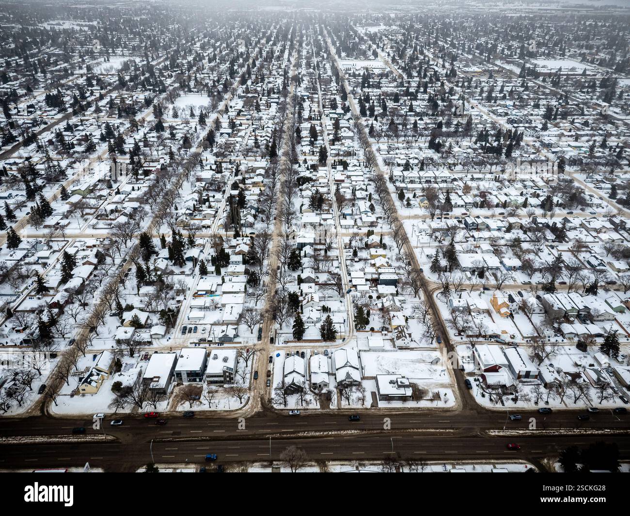 Snowy cityscape with houses and cars. The houses are mostly empty and ...