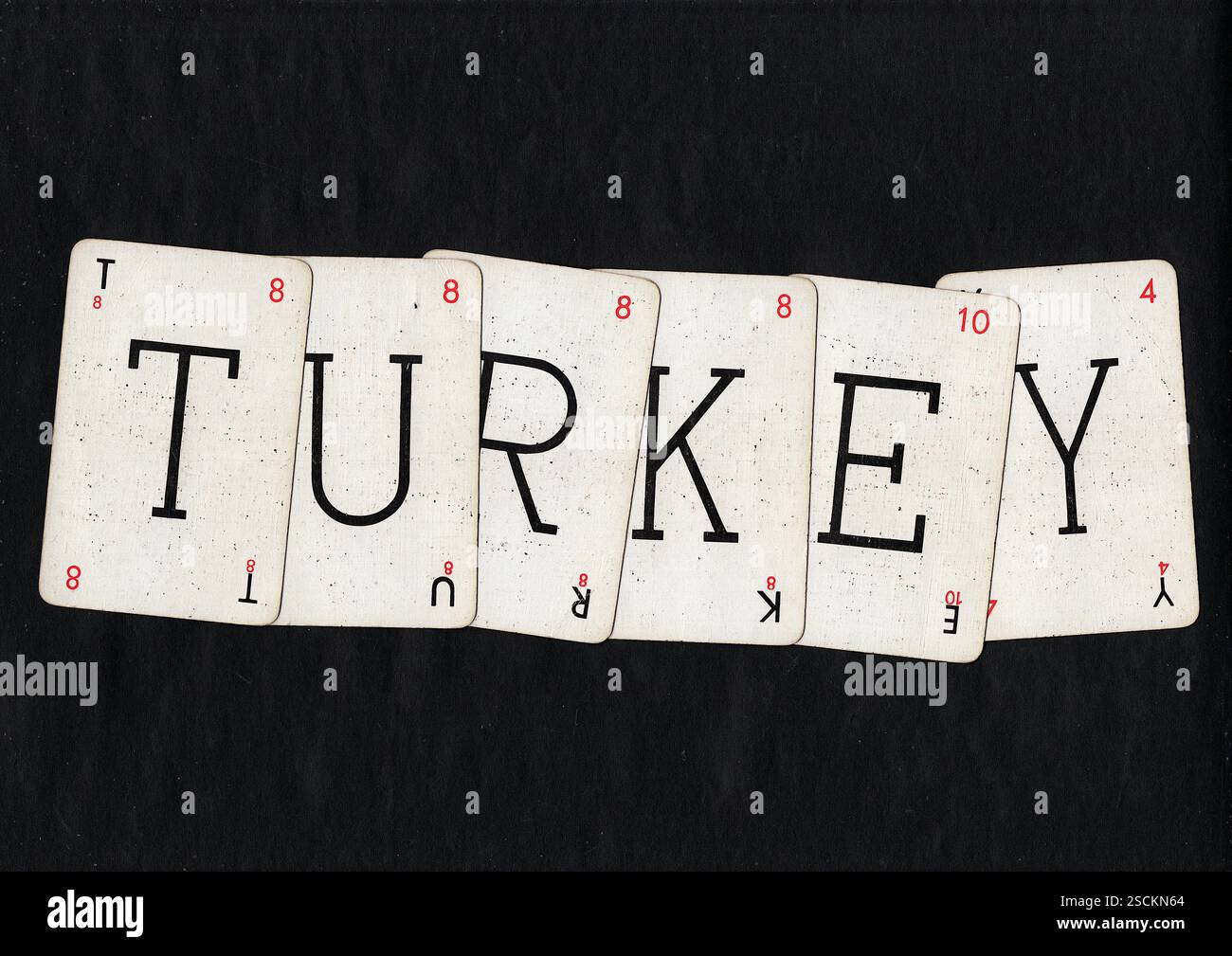Vintage word game playing cards spelling TURKEY isolated on a black ...