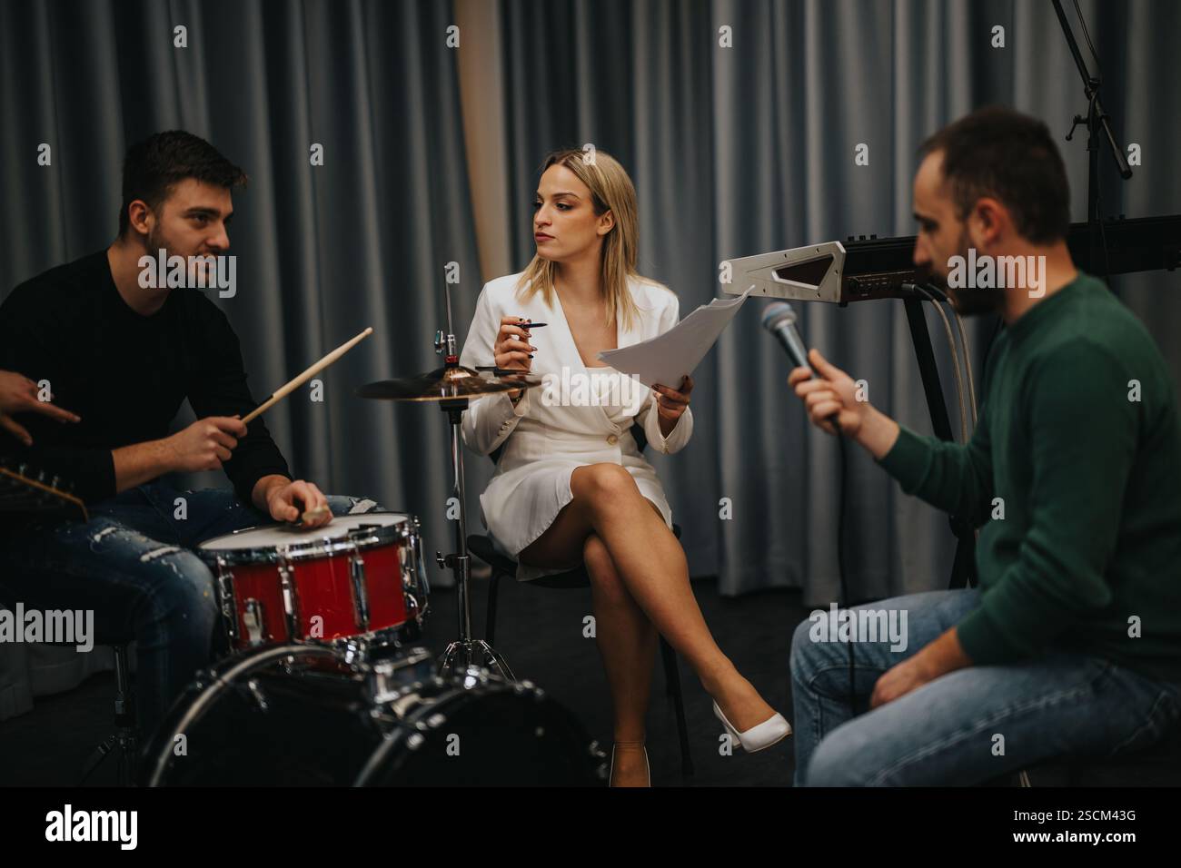Group of musicians rehearsing in a recording studio setting Stock Photo ...