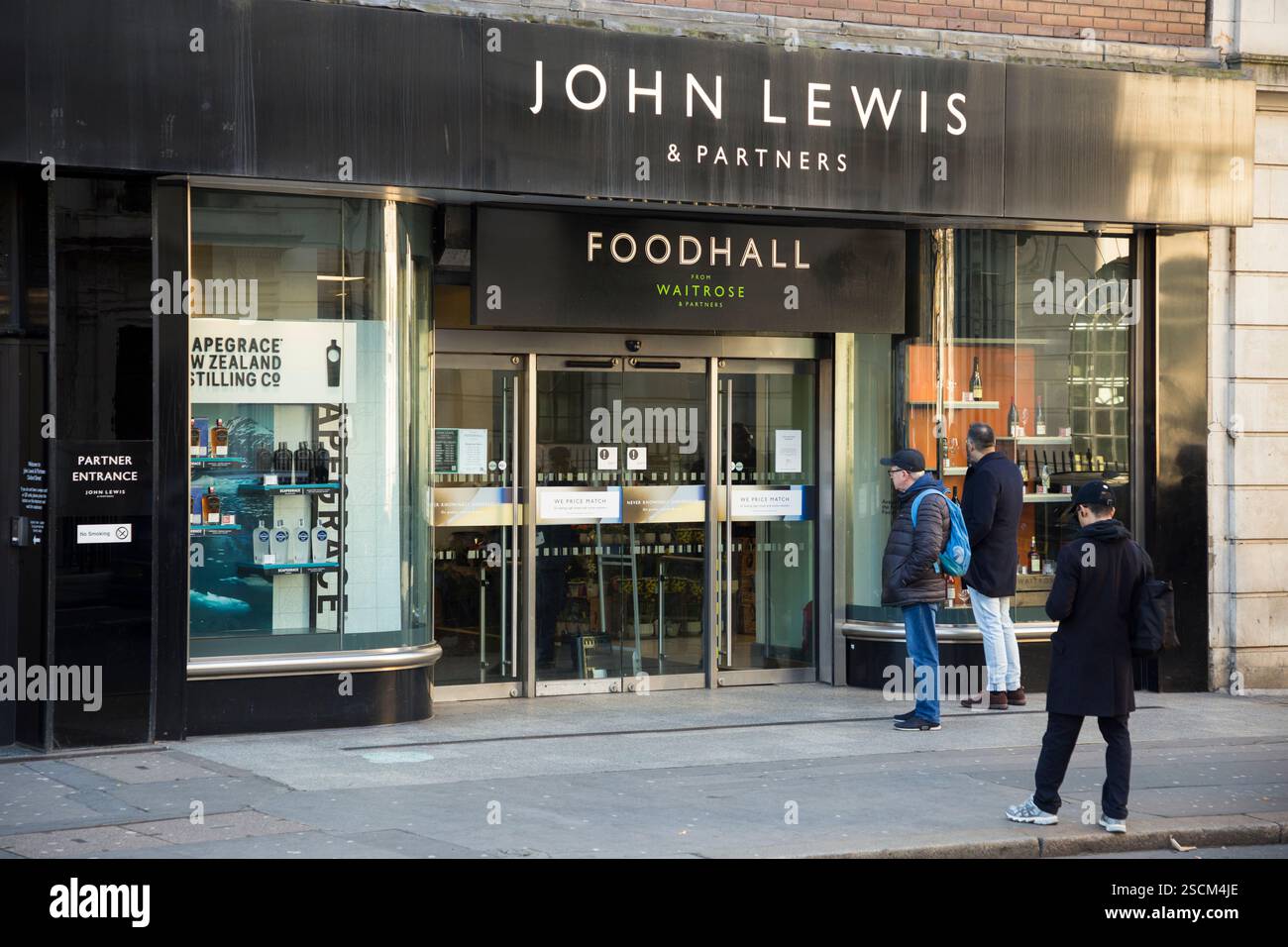 People in an informal queue wait for John Lewis store to open on a ...