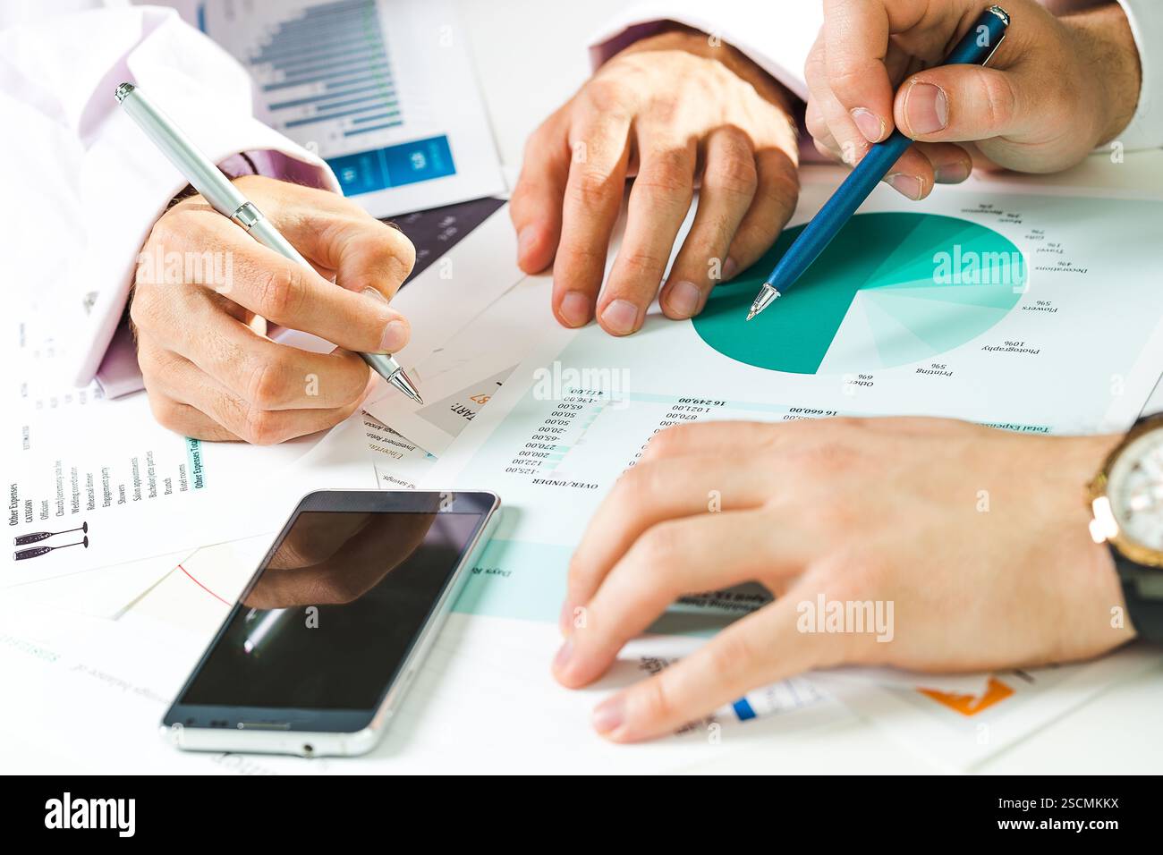 Group collaborates on business analysis drafting reports and examining ...