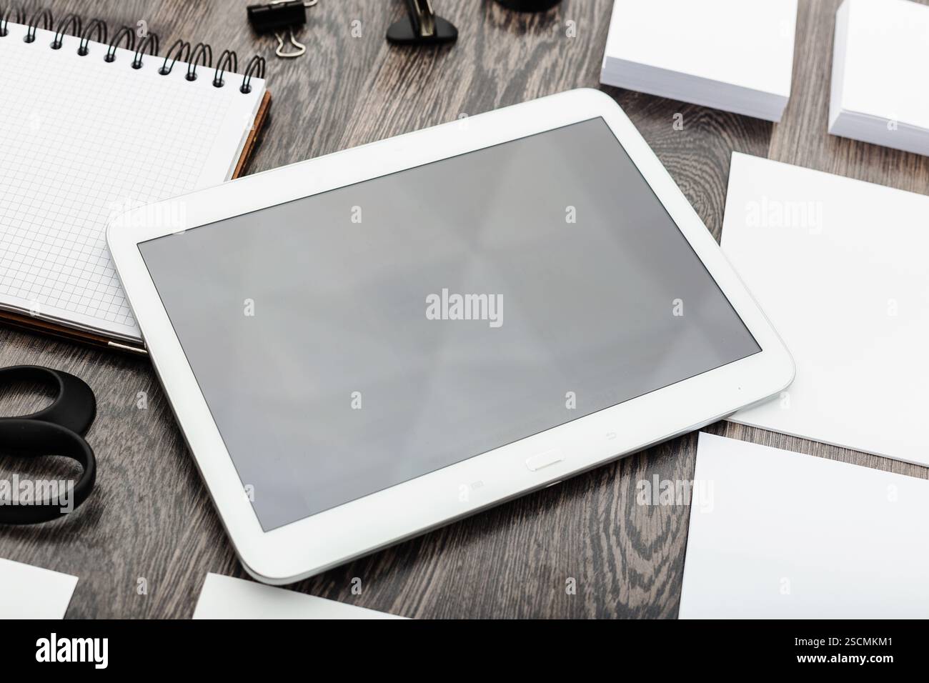 Office workspace with tablet and stationery items on wooden desk for ...