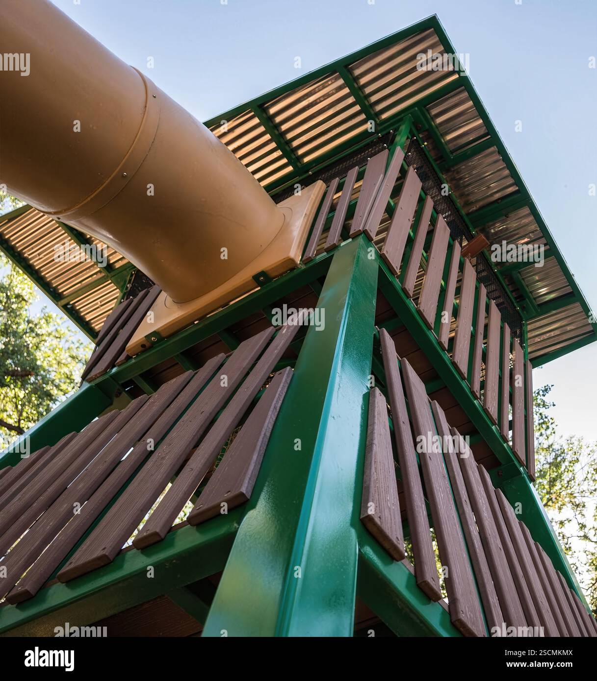 Green Playground Slide Tower: Upward view of a green playground slide ...