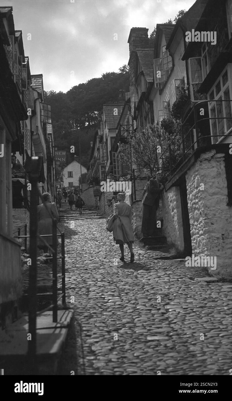 1950s, historical, two ladies walking up on the steep narrow cobbled ...
