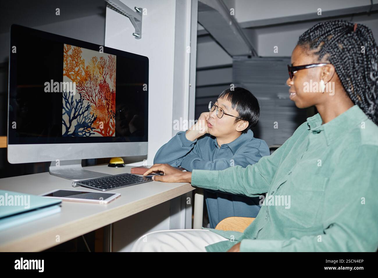 Two colleagues working on a computer project in modern office ...