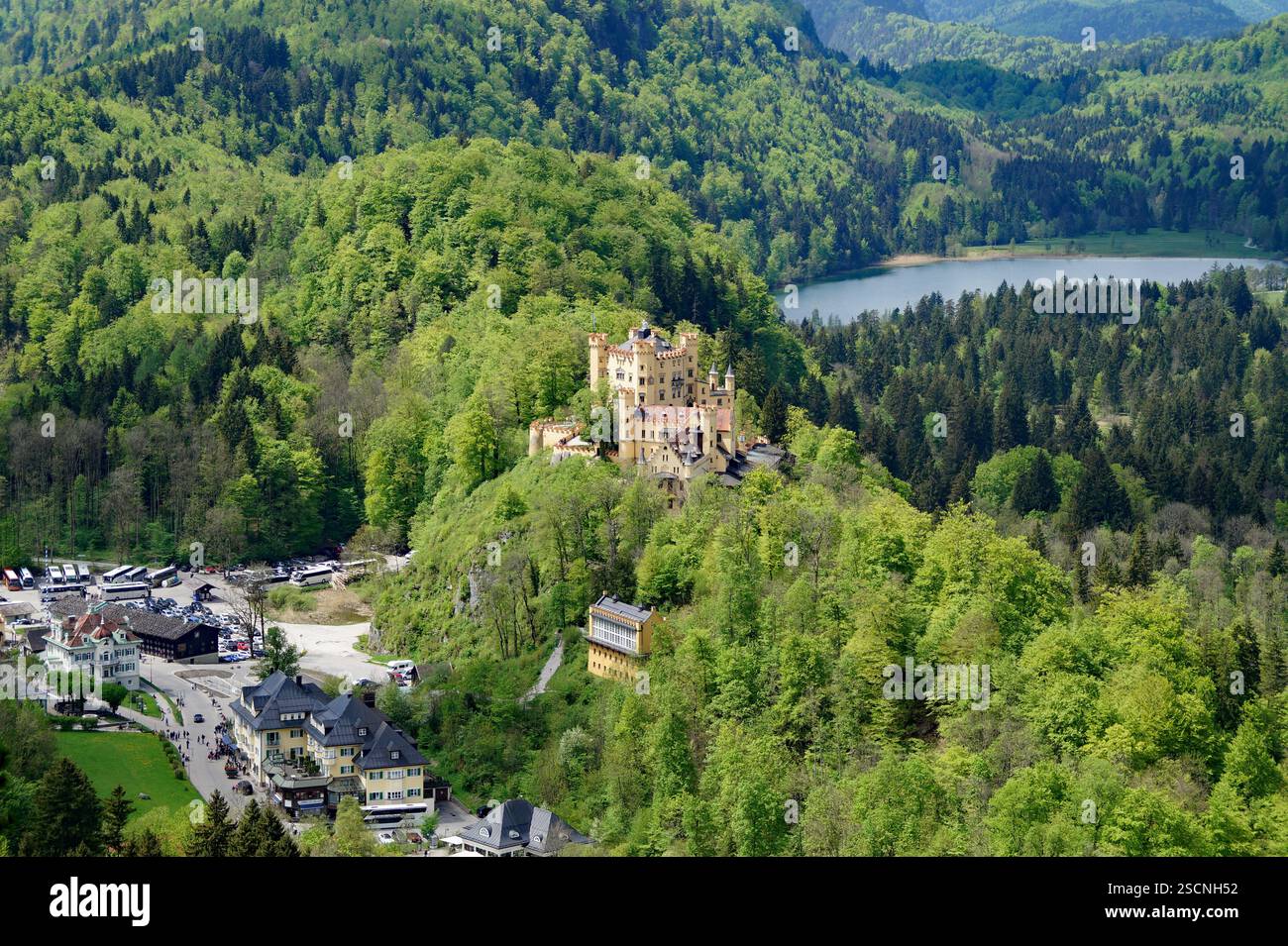 Hohenschwangau Castle in the Bavarian Alps surrounded by the woods and ...