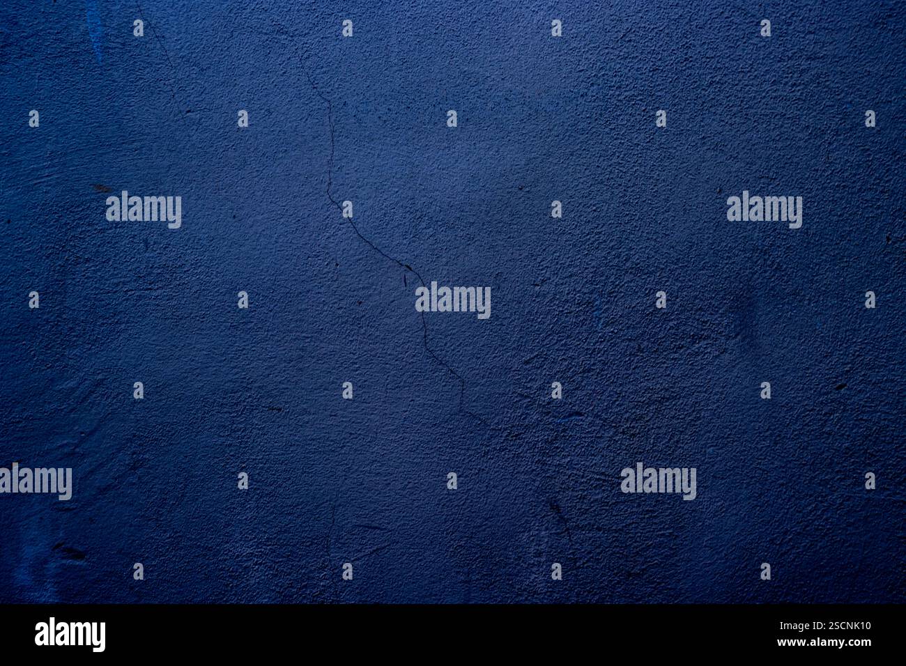 Abstract image of a dark blue textured wall with fine cracks, making it ...