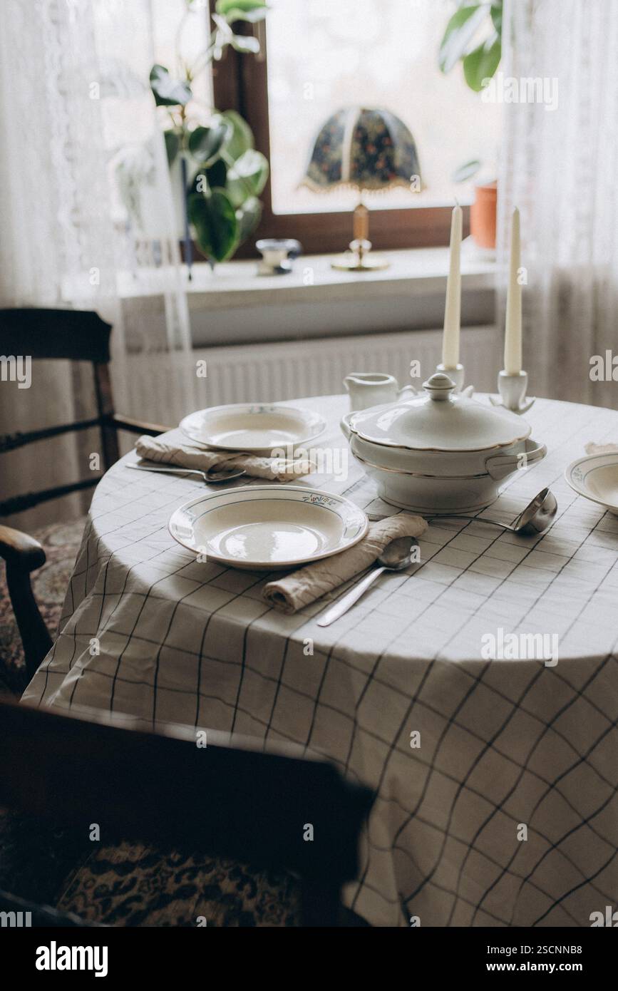 an elegantly set vintage dining table, beautifully arranged for a ...