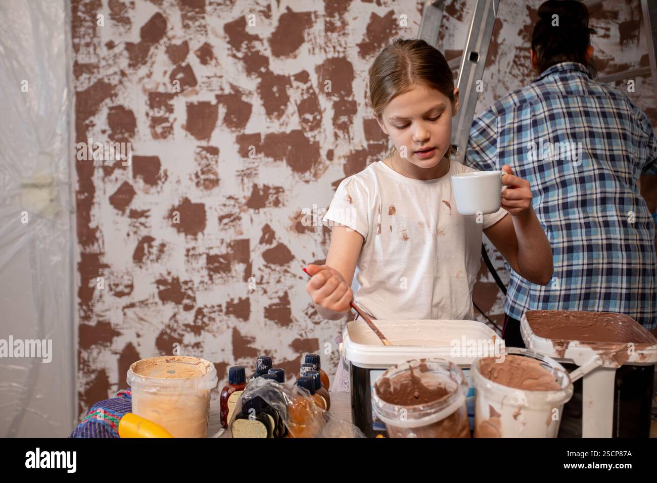 A Child Engaging in Painting Within the Scope of Home Renovation ...
