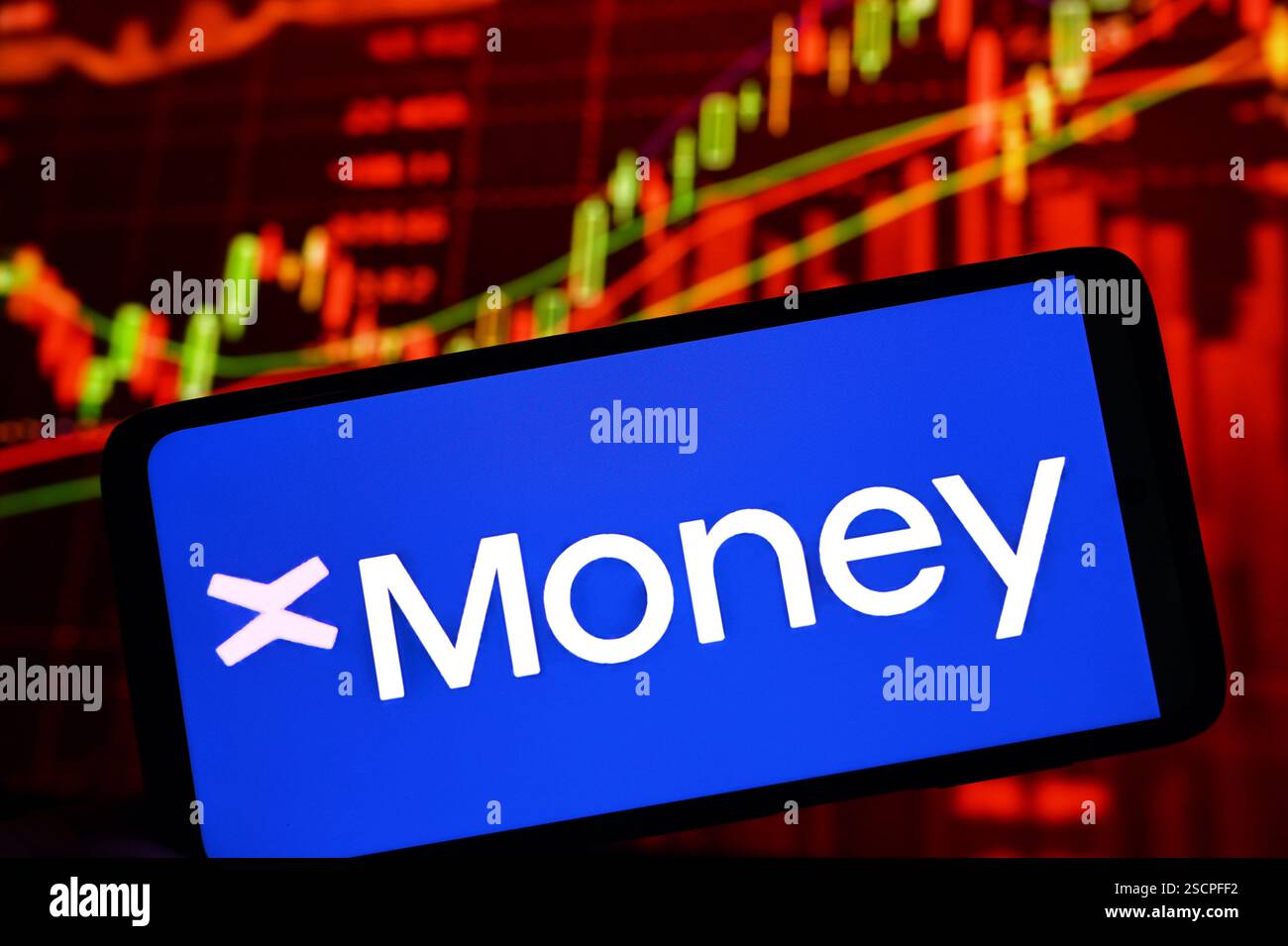 In this photo illustration, the xMoney logo is seen on a smartphone and ...