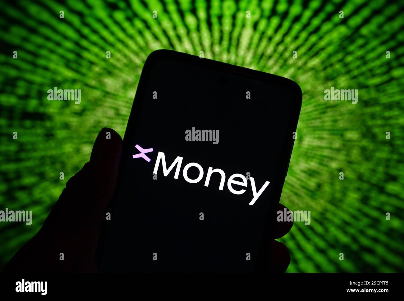 In this photo illustration, the xMoney logo is seen on a smartphone ...