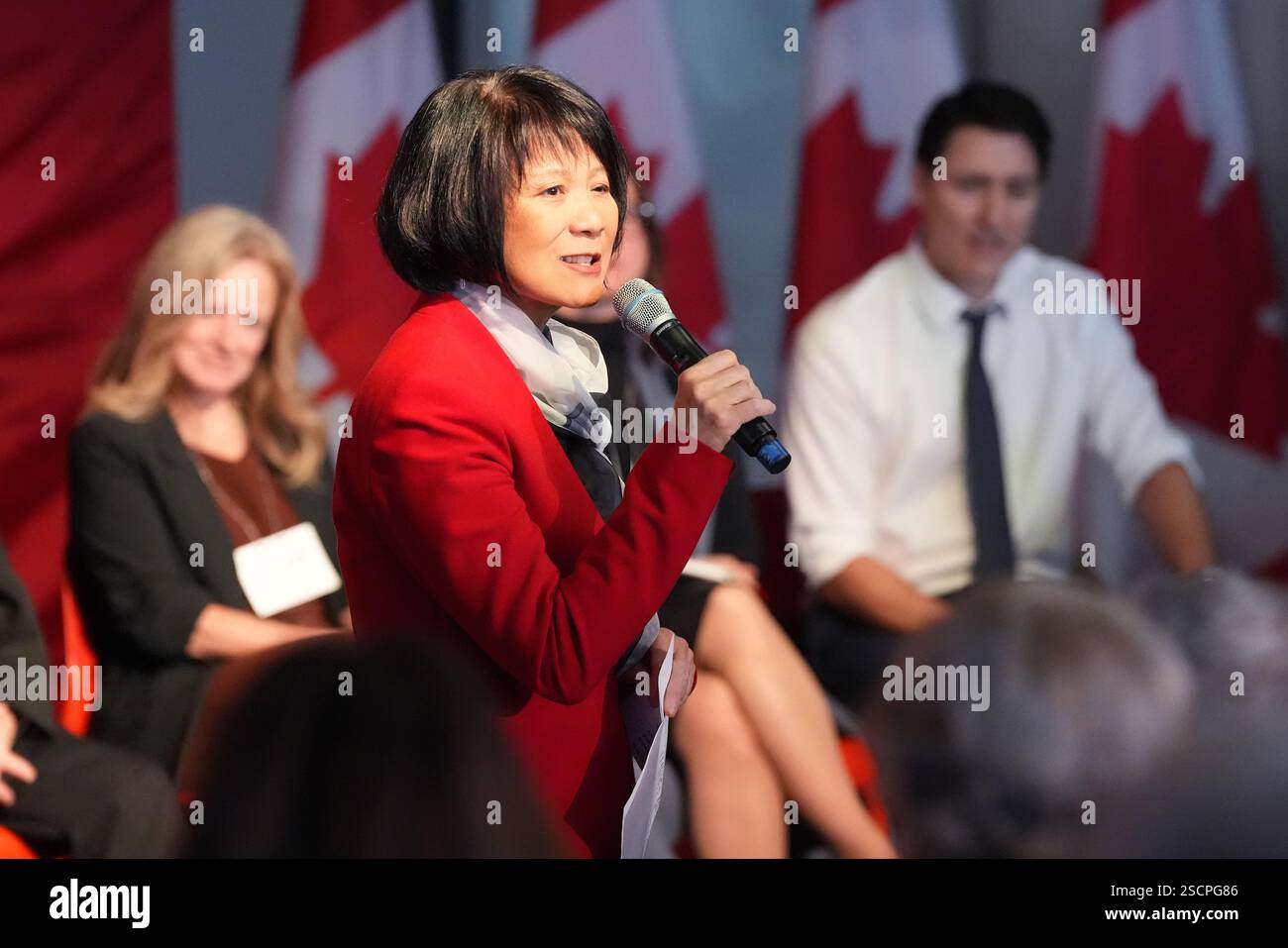 Prime Minister Justin Trudeau (back right) and former Alberta premier ...