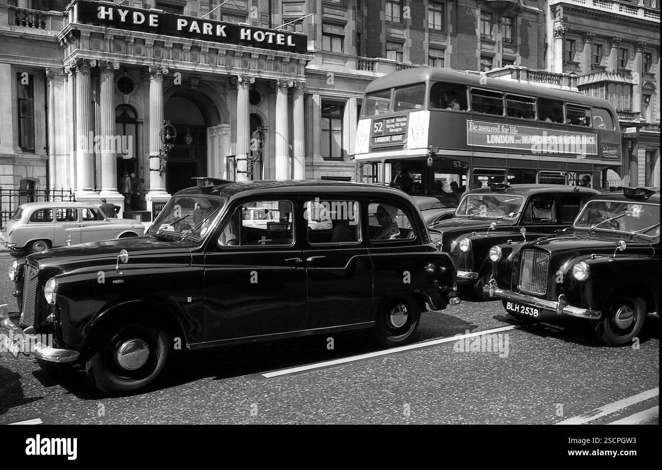 Cabs, double-decker bus and the Hyde Park Hotel in London. [automated ...