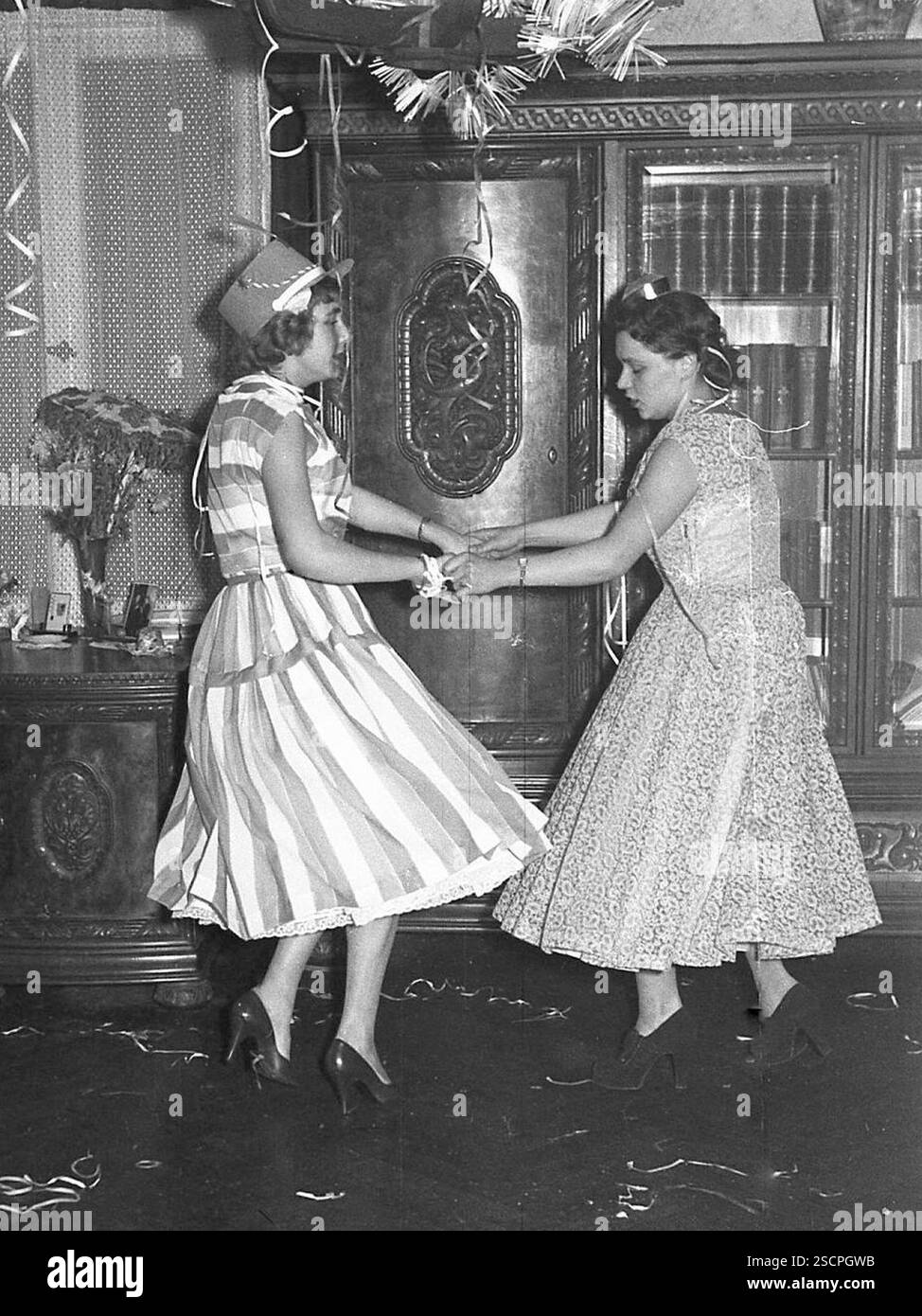 Two young women dancing at a carnival ball in the GDR, 1956. [automated ...