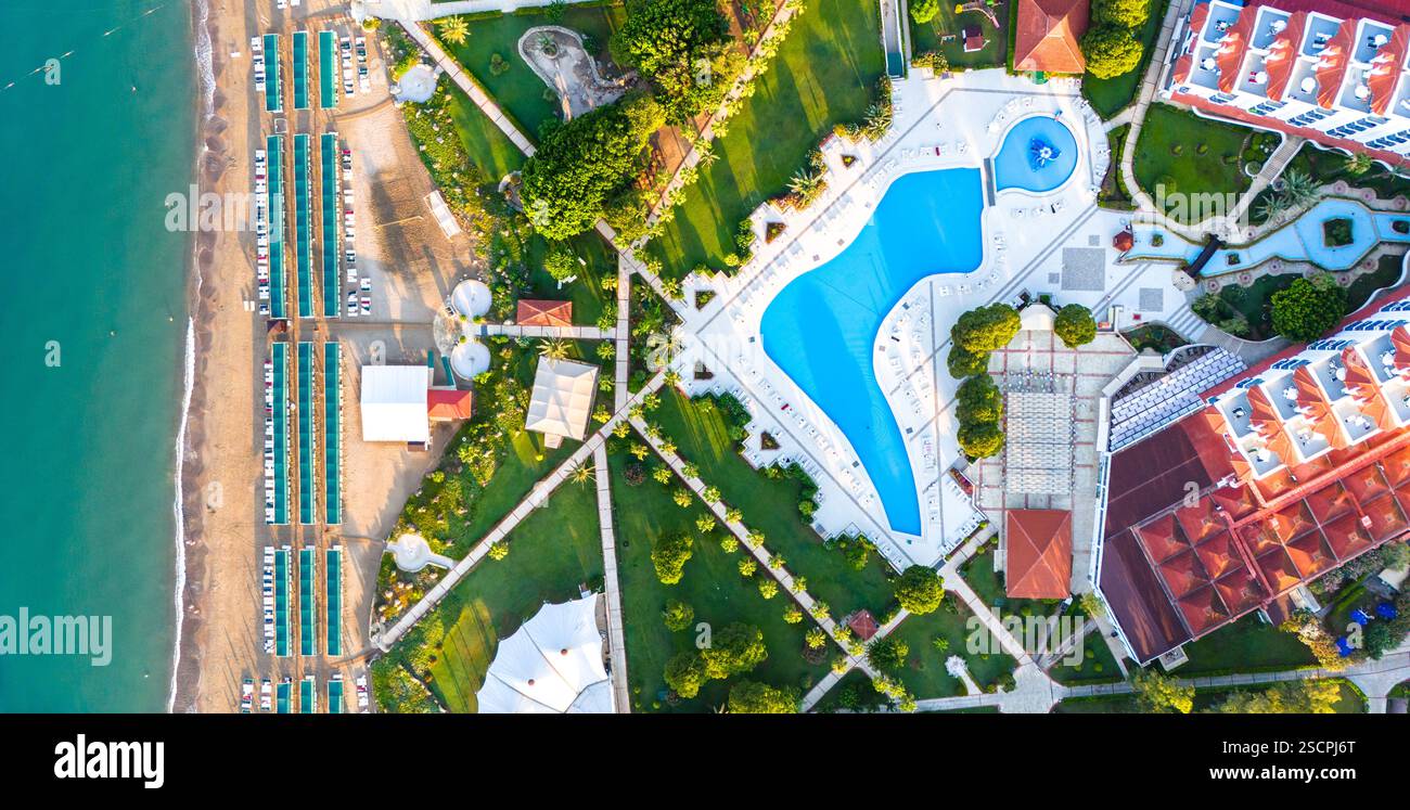 Aerial view of a beachfront luxury resort with pools, gardens, and a ...