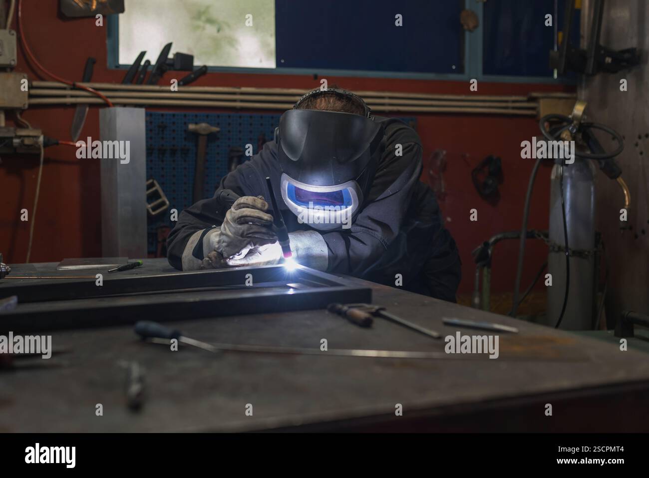 Welder making a construction, skilled and precision welding metal parts ...