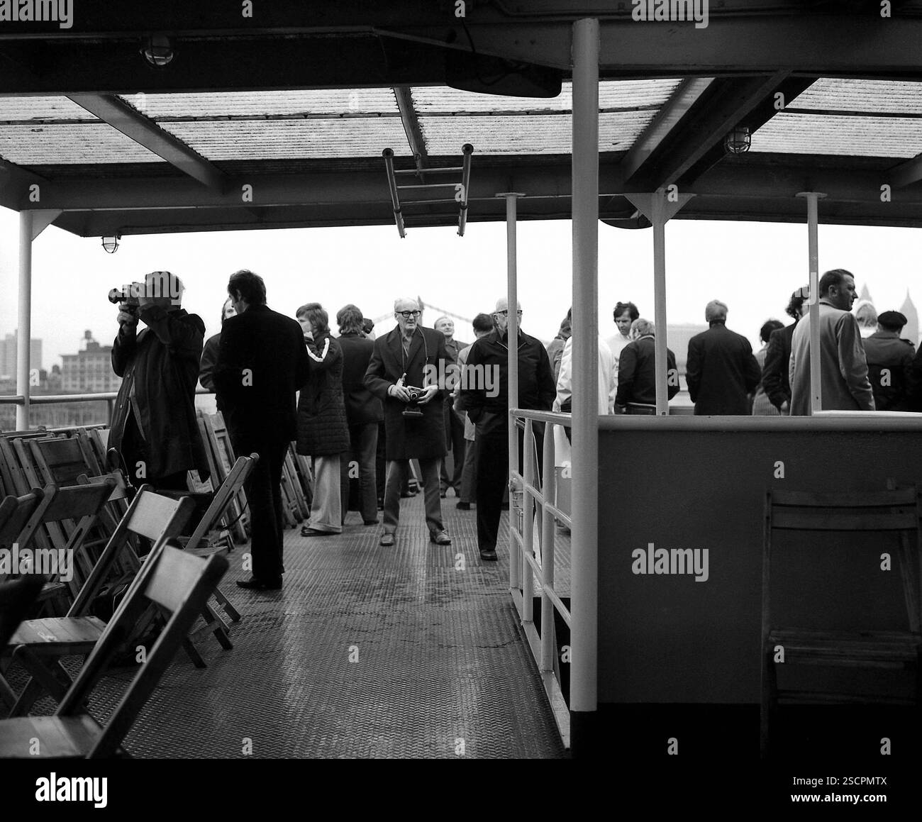 Tourists with cameras on the deck of a Circle Line ferry on the Hudson ...
