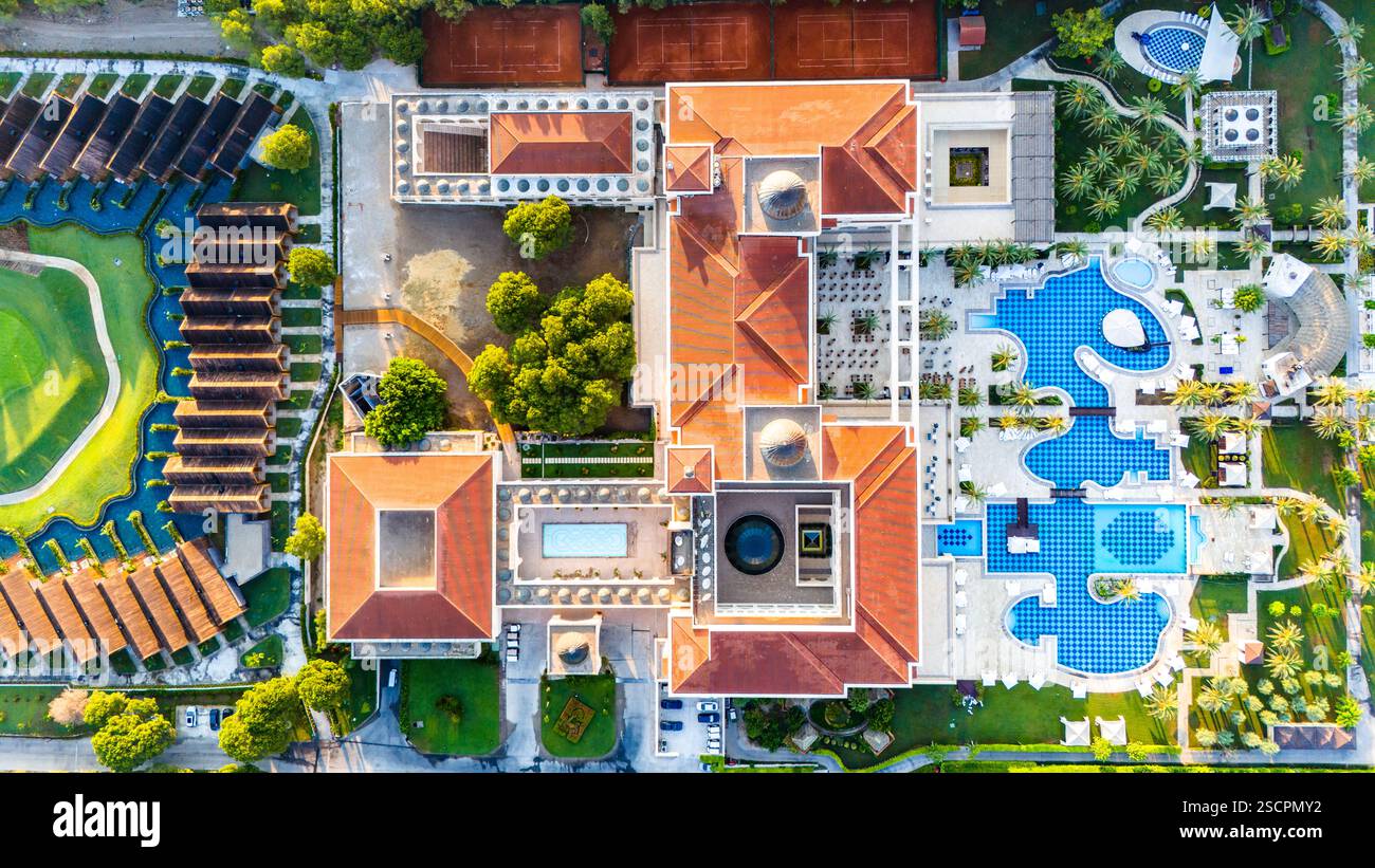Aerial view of a luxury resort with pools, lush gardens, and a golf ...