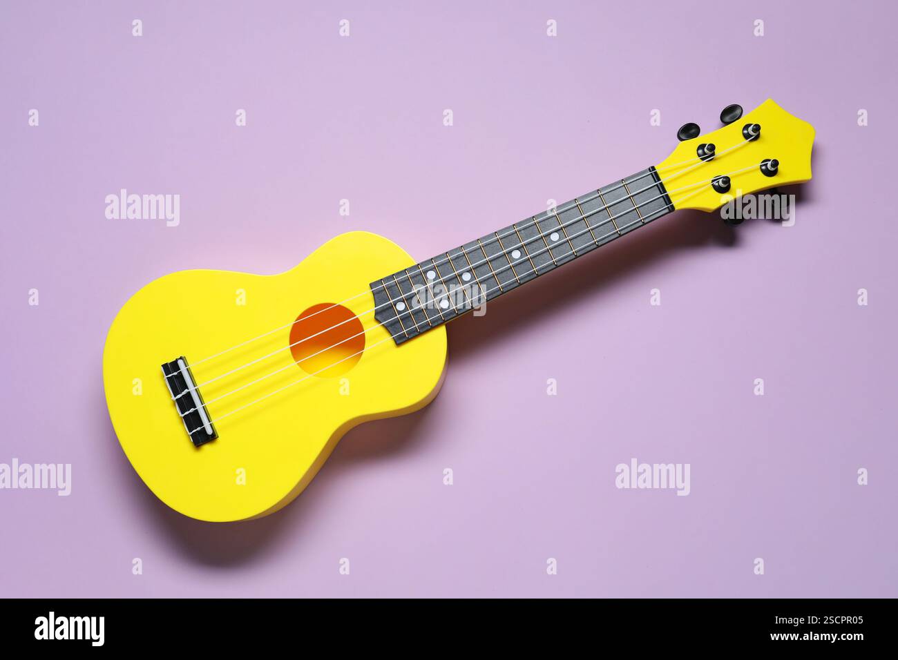 One ukulele on violet hi-res stock photography and images - Alamy