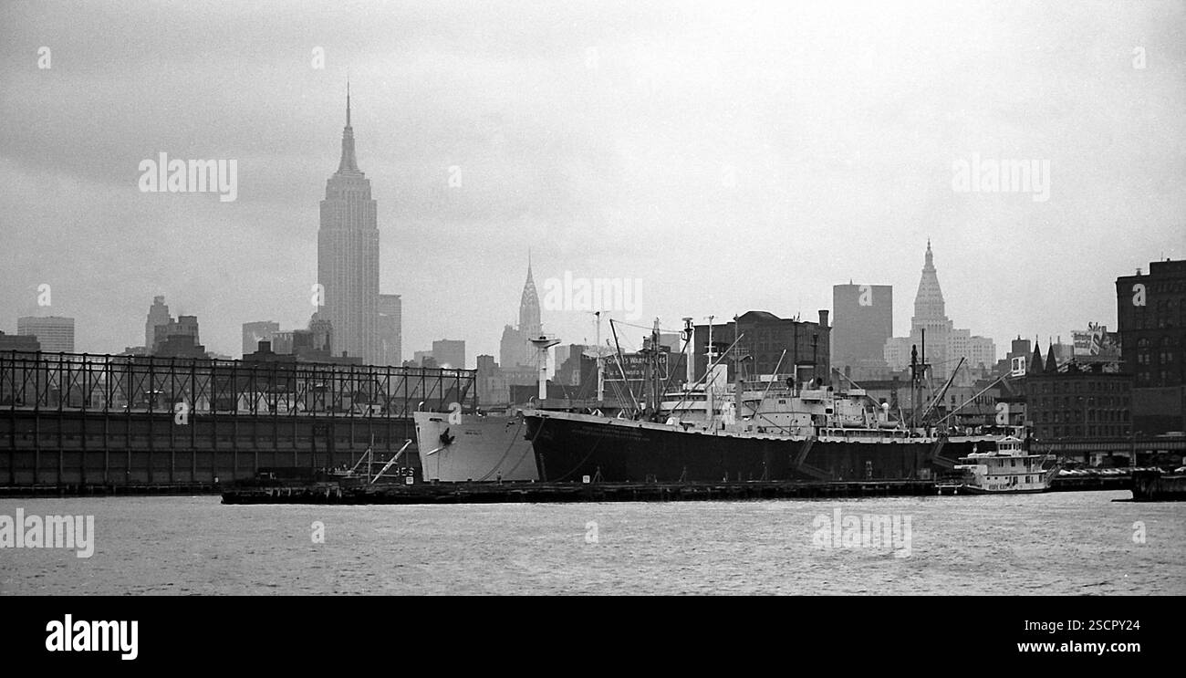 Freighter in Hudson Harbor in New York City. The Empire State Building ...