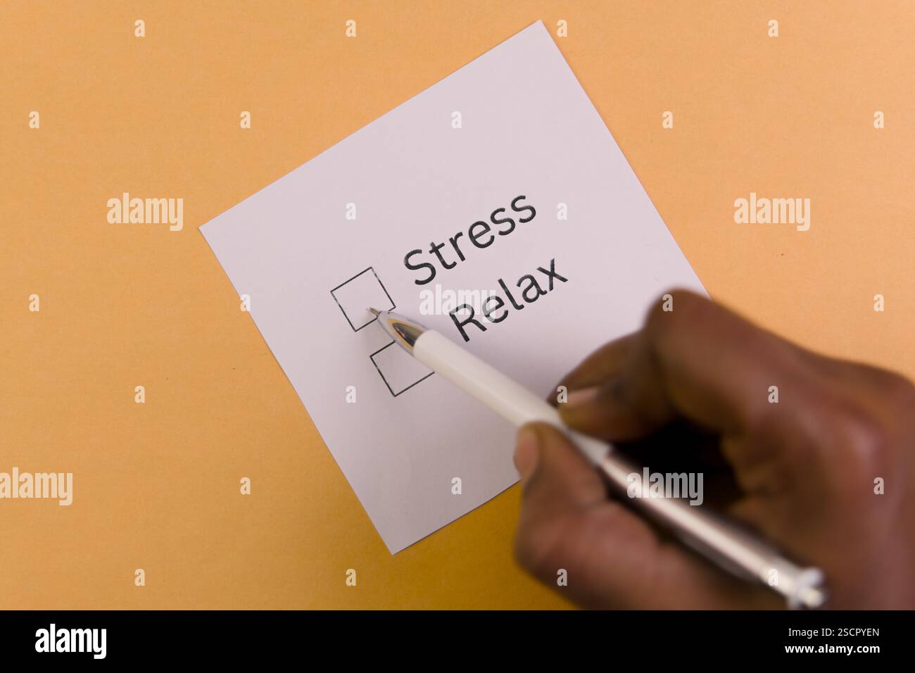 A hand holding a pen marks options on a checklist for stress and ...