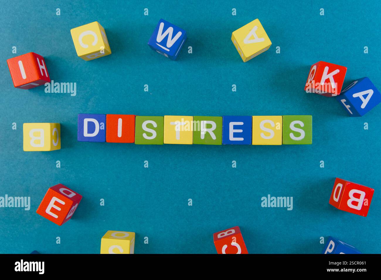 Colorful building blocks arranged to form the word distress on a ...