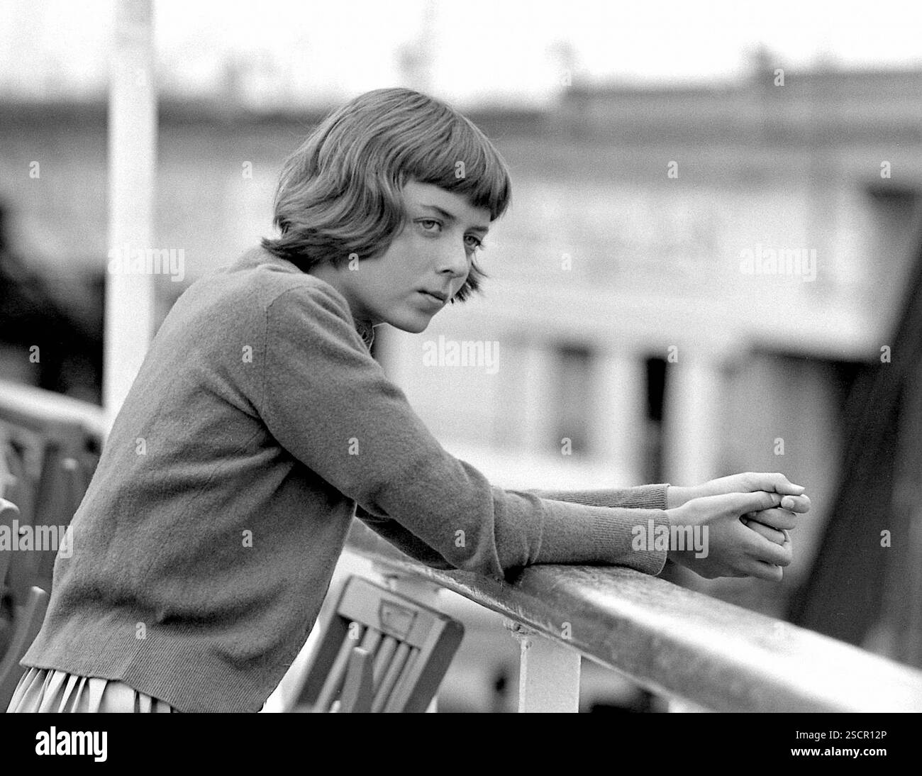 A young woman looks out over the port of Rotterdam from the deck of the ...