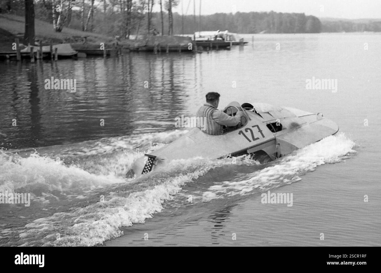 A man sits in a speedboat and sails on the Scharmützelsee in ...