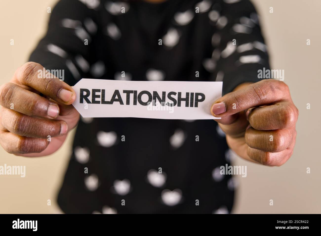 A person shows a sign reading relationship, emphasizing connection and ...