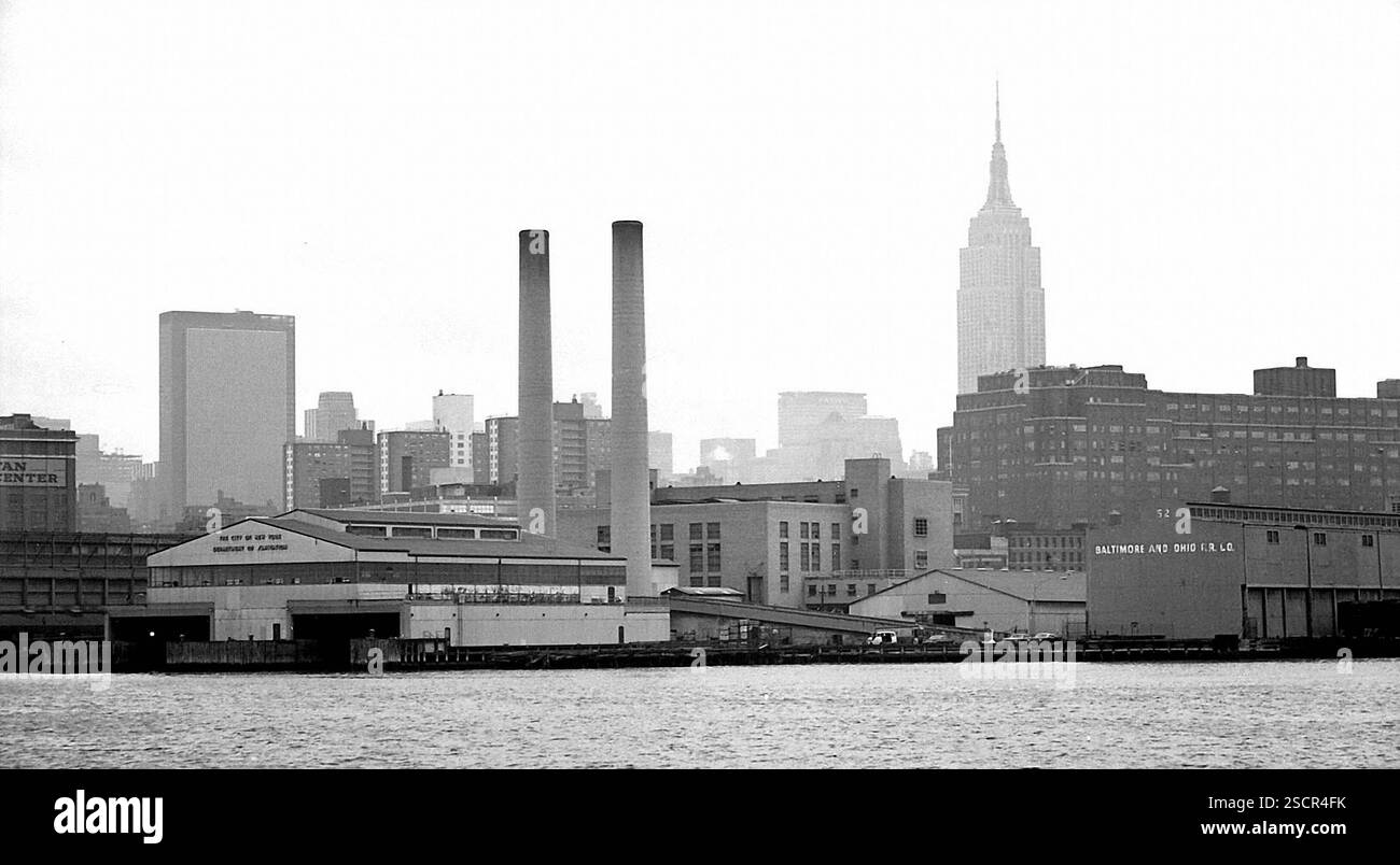 Warehouses on Hudson Harbor in New York City. The Empire State Building ...