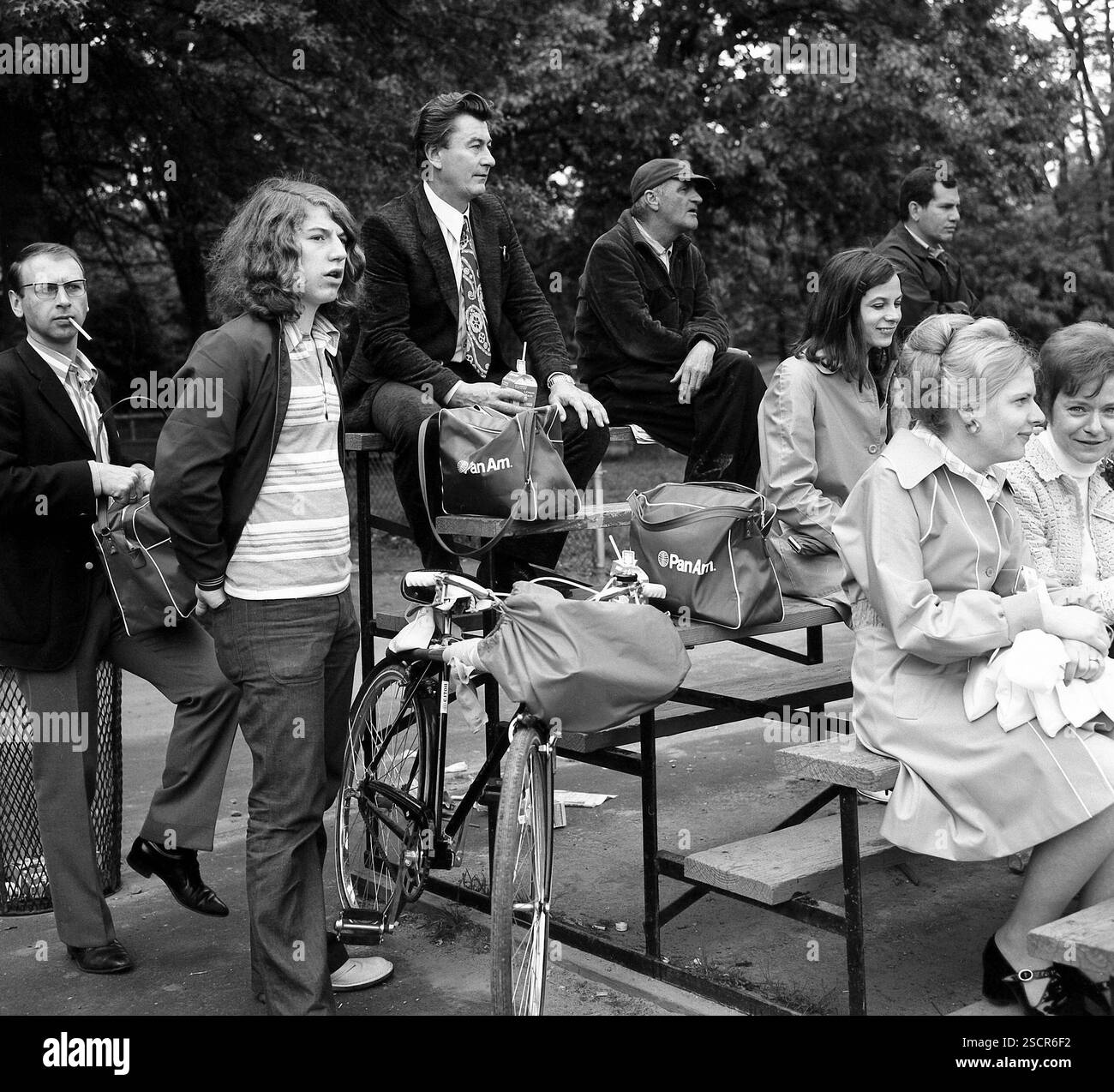 A group of people sit on a grandstand in Central Park in New York City ...