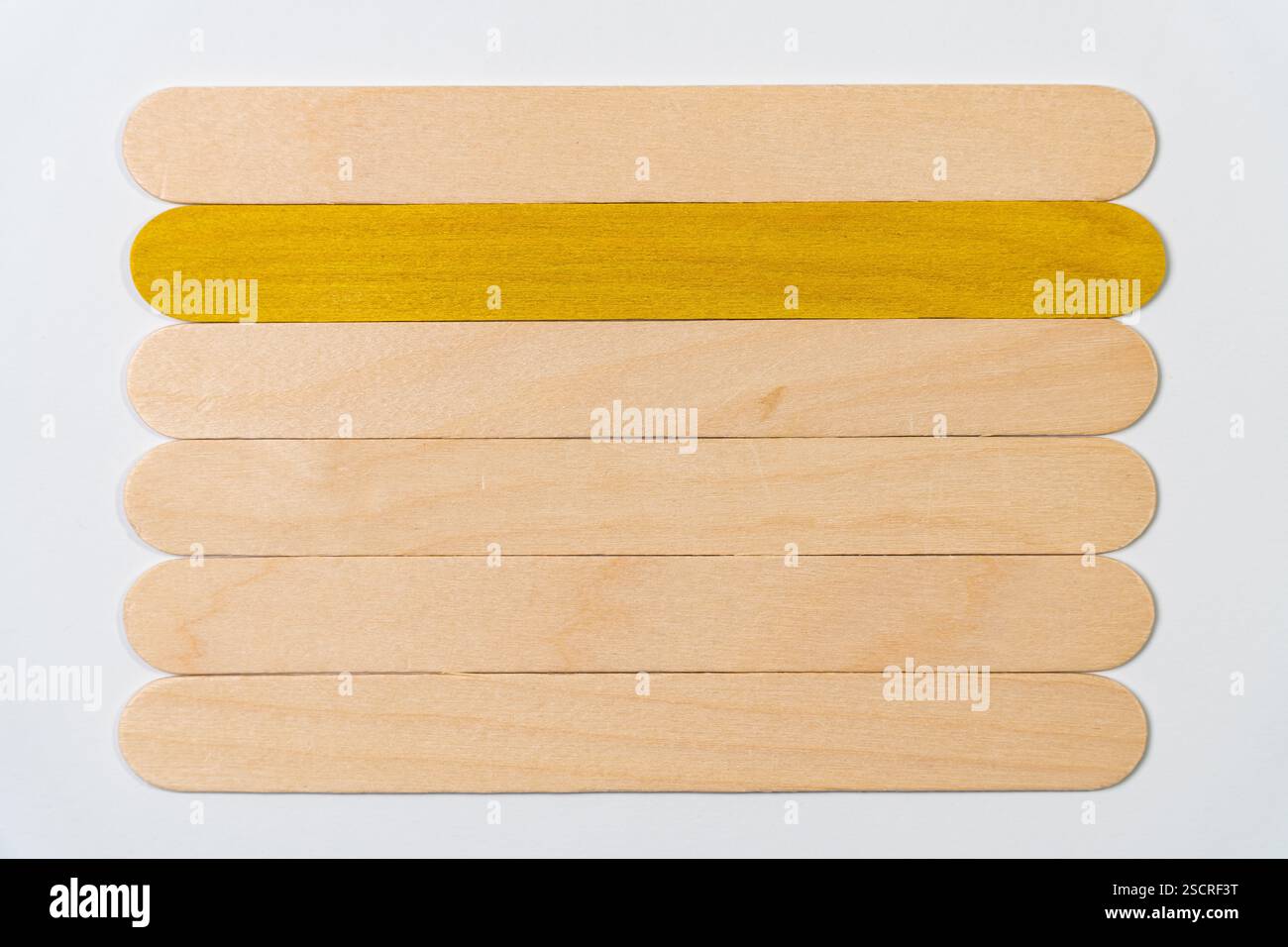 Stack of Wooden Sticks with One Yellow Stick in the Center Stock Photo ...