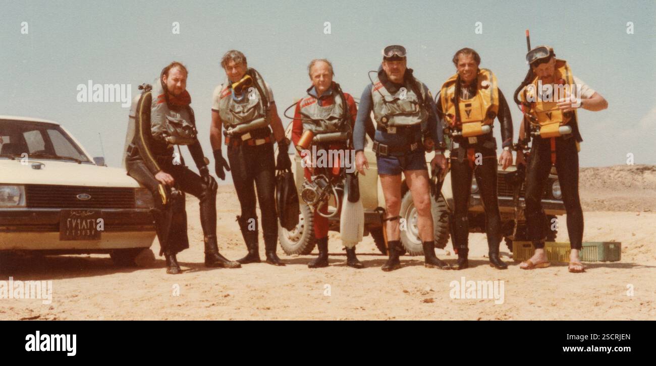 A group of scuba divers in diving gear in the Sinai desert. [automated ...