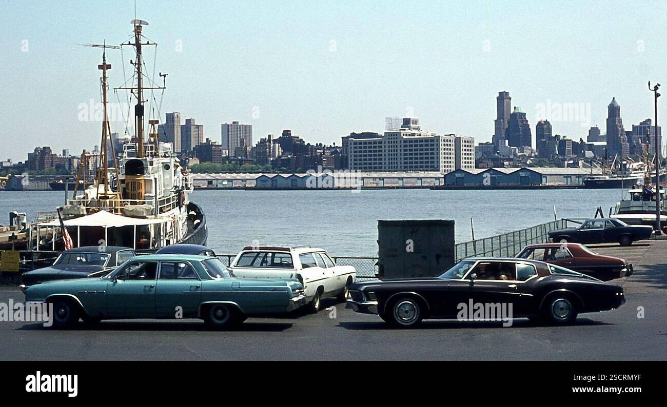 A ferry at a dock on Governors Island in New York. The skyscrapers of ...