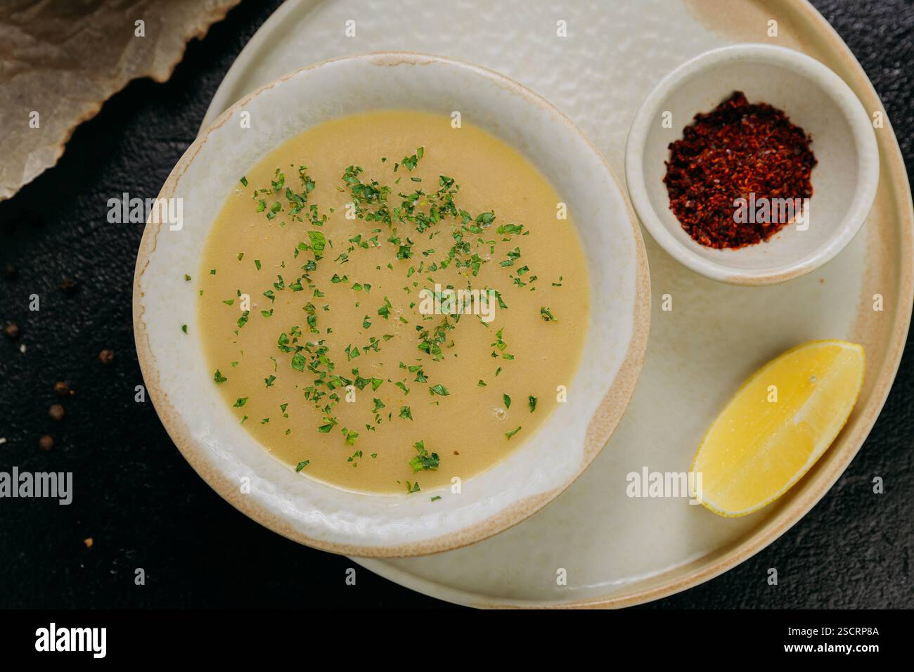 Creamy lentil soup with flatbread, sesame seeds, chili flakes, and ...